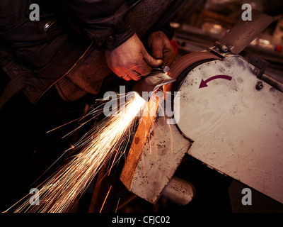 Worker grinding a metal plate Stock Photo - Alamy