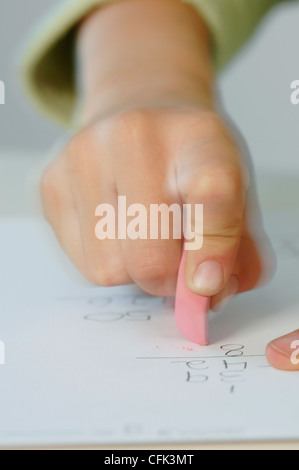 Child Erasing Work from Paper Stock Photo - Alamy