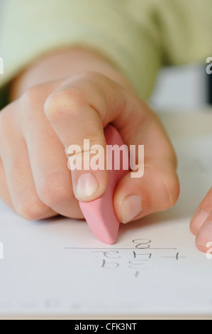 Child Erasing Work from Paper Stock Photo - Alamy
