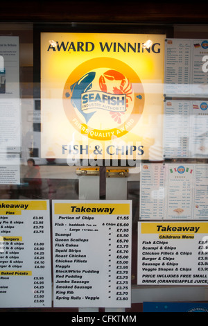 Good old fashioned fish and chips with mushy pea's being served in a ...