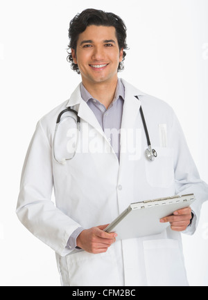 Studio shot of young man doctor wearing eyeglasses while pointing ...
