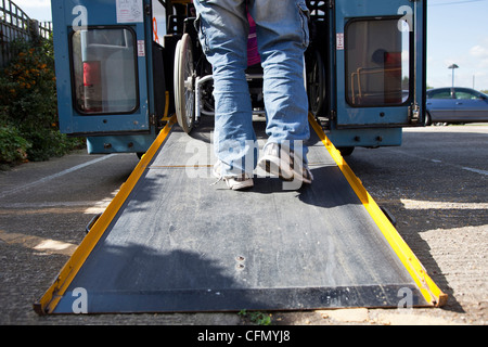 Wheelchair being pushed up ramp on to bus Stock Photo - Alamy