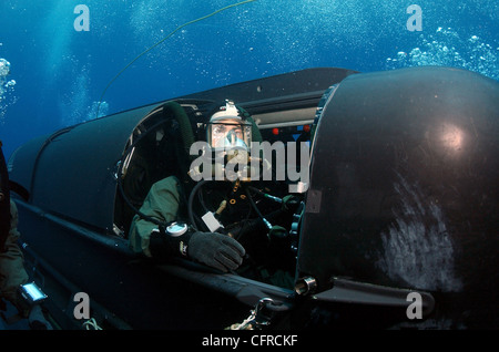 A member of SEAL Team Two climbs aboard a SEAL Delivery Vehicles before ...