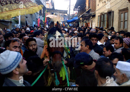 Kashmiri Shiite Muslim perfoming the ritual of "Tatbir" by slicing his ...