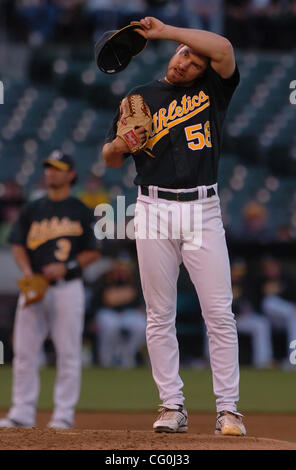 Oakland Athletics pitcher Lenny DiNardo talks to catcher Kurt Suzuki in ...