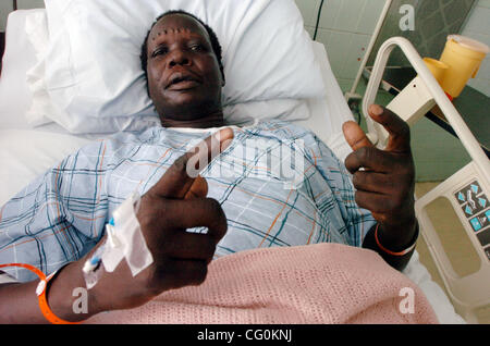 Simon Deng, 47, of Manhattan lies in a hospital bed at Harlem Hospital ...