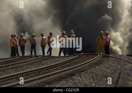 As the train trestle fire continued Friday, a Union Pacific crew and ...