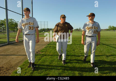 Yuba City High School head coach Jim Stassi takes the gloves of his son ...
