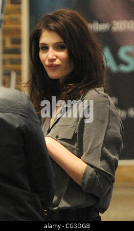 Gemma Arterton shares a rather animated conversation with friends ...