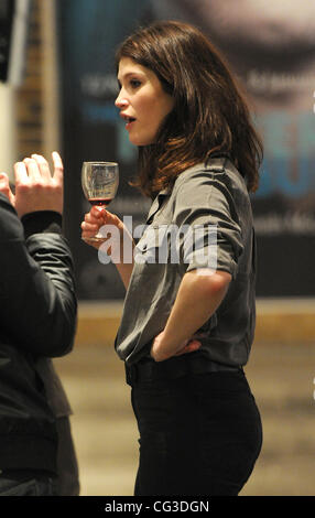 Gemma Arterton shares a rather animated conversation with friends ...