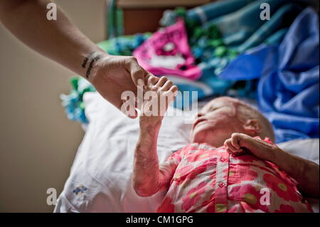 Burn survivor, Isabella "Pippie" Kruger is comforted by her mother ...