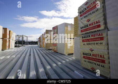 Roofer workers place metal roofing sheets on wooden joins structure in ...
