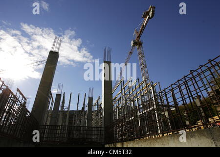 Roofer workers place metal roofing sheets on wooden joins structure in ...
