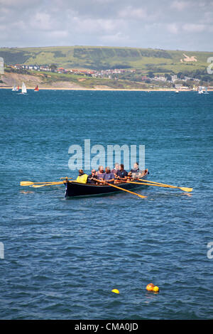 Swanage Sea Rowing Club in Dancing Ledge gig holding oars up at Swanage ...