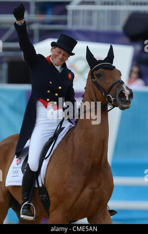 Equestrian performing dressage in arena. Professional female jockey in ...