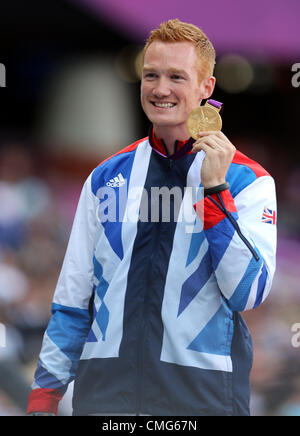 Greg Rutherford, long jump gold medalist, waves as the parade ...