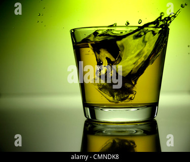 Colorful splashing drink with reflections Stock Photo - Alamy