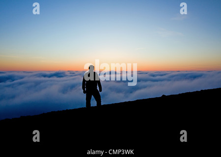 Cloud inversion UK - silhouette of a man walking in the Campsie Fells ...