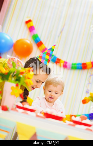 Mother and baby having fun at birthday party Stock Photo - Alamy