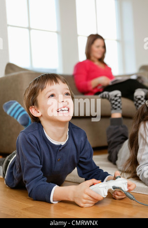 Happy smiling family with children palying on carpet in living room ...