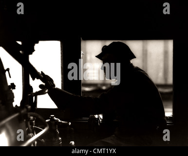 1920s 1930s 1940s RAILROAD TRAIN ENGINEER LOOKING OUT WINDOW OF ...