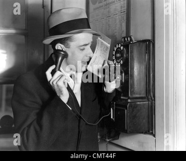 1930s BUSINESSMAN TALKING ON PUBLIC PAY TELEPHONE IN PHONE BOOTH Stock ...