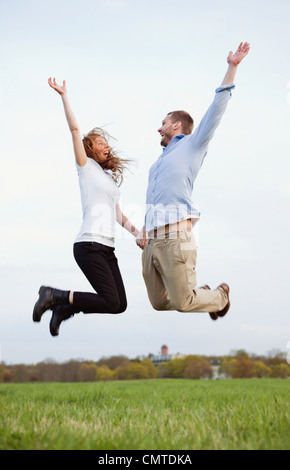 couple jumping together Stock Photo - Alamy