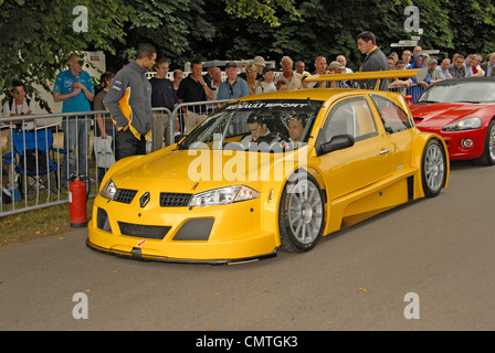 Classic saloon cars racing at the Goodwood Revival. Group of vintage ...