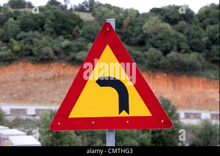 Greek traffic sign indicating a sharp left turn Stock Photo - Alamy