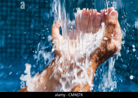 Water pouring with power into the hands of a woman Stock Photo - Alamy