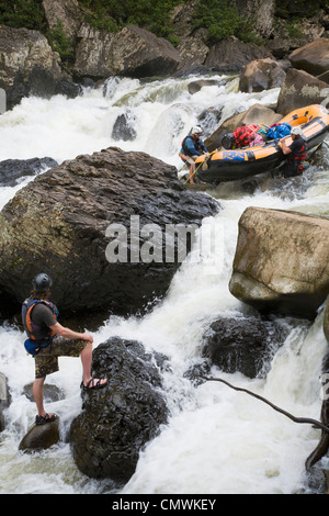 River guides drag their raft over rocks during a rafting expedition on ...