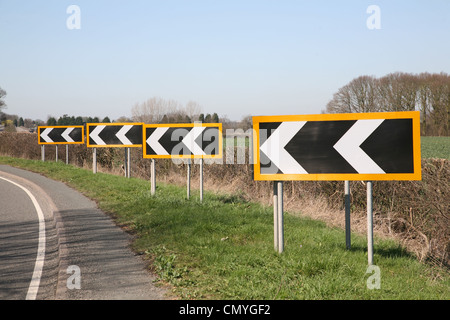 road signs warning drivers of a sharp bend ahead Stock Photo - Alamy