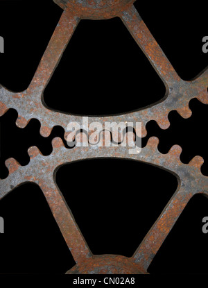 Rusty cogs against a black background Stock Photo - Alamy