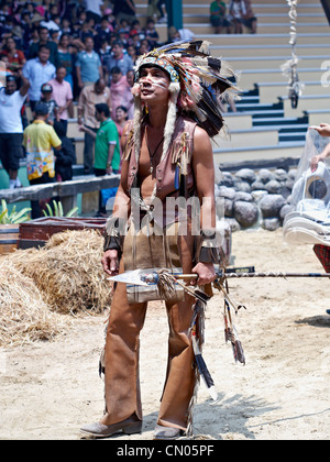 A Native American dressed in a traditional outfit performs a dance at ...