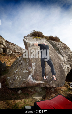 Climber bouldering at Back Bowden Doors, Nr. Belford, Northumberland ...