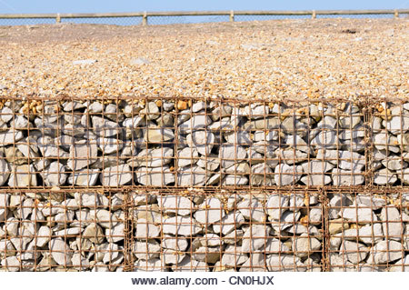 Detail of sea defence wall of gabions or wire nets containing large ...