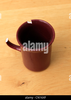 Red Mug Chipped On The Rim Stock Photo - Alamy