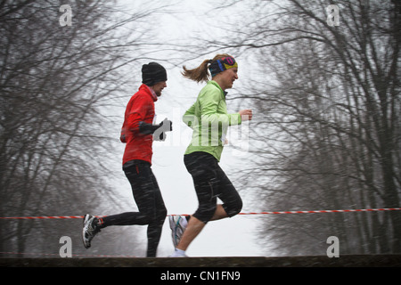Girl athlete running in winter park on morning run Stock Photo - Alamy