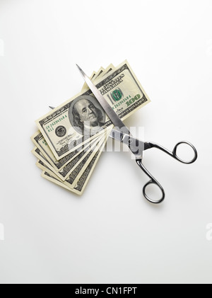 scissors cutting American 100 hundred dollar bill money on white ...