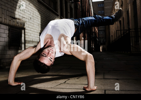 Muscular young man leaning back Stock Photo - Alamy