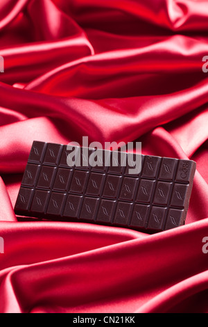A vertical image of a large chocolate bar with a creamy, gooey center ...
