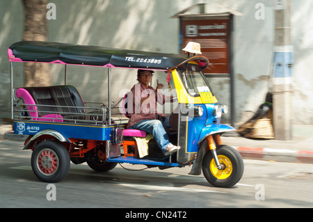 BANGKOK - THAILAND: A tuc tuc driver poses in the streets of Bangkok ...