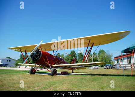 Biplane at an old fashioned airfield. This maroon fabric covered Stock ...