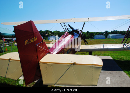 Biplane at an old fashioned airfield. This maroon fabric covered ...