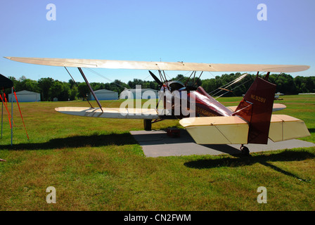 Biplane at an old fashioned airfield. This maroon fabric covered ...