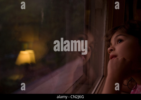 Girl at night with window reflection Stock Photo - Alamy