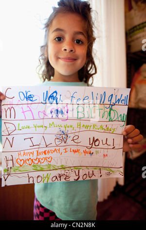 Girl holding a piece of paper Stock Photo - Alamy