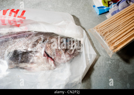 Fresh fish in a plastic bag at a local market Stock Photo - Alamy
