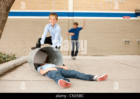 Boy bullying a group of three school girls Primary school pupils seated ...