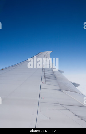 Plane wing from inside an airplane Stock Photo - Alamy
